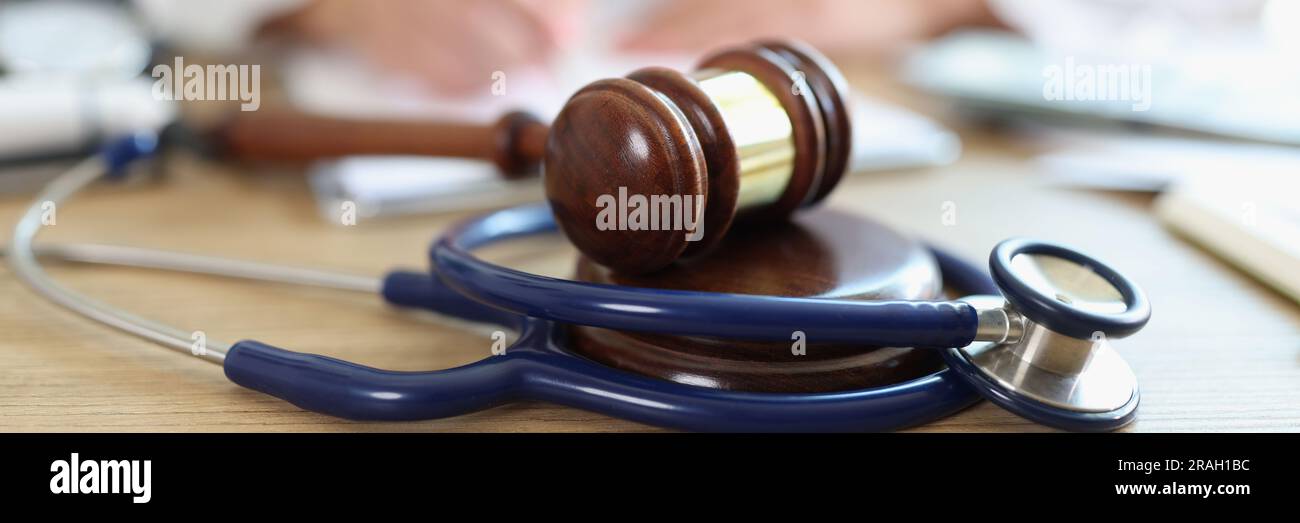 Judge hammer and doctor stethoscope on office desk Stock Photo - Alamy