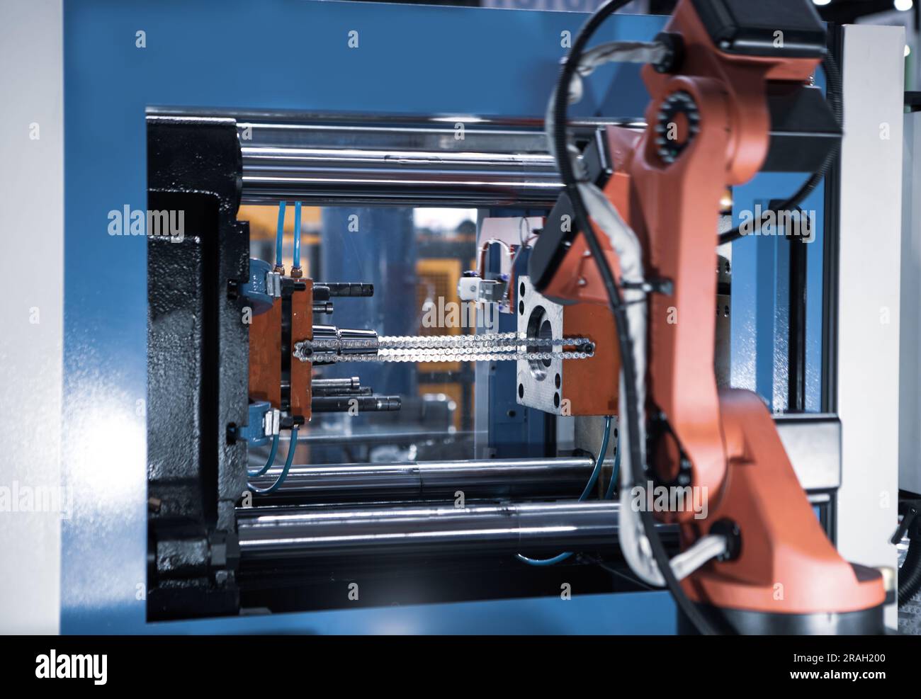 Automated manufacturing process. Robot arm remove finish products on ...