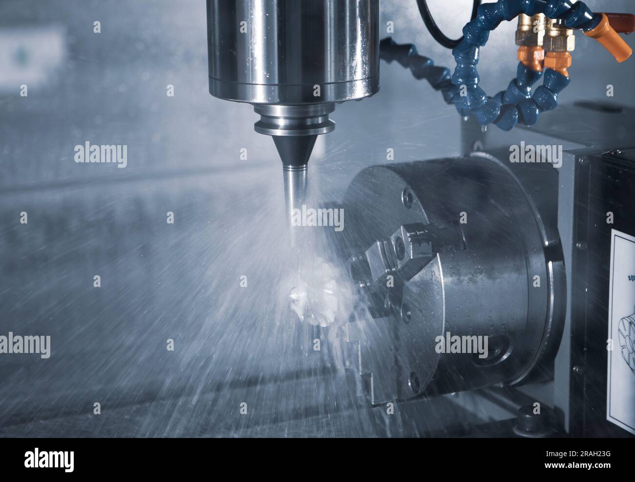 High precision CNC milling machine cutting workpiece with coolant ...