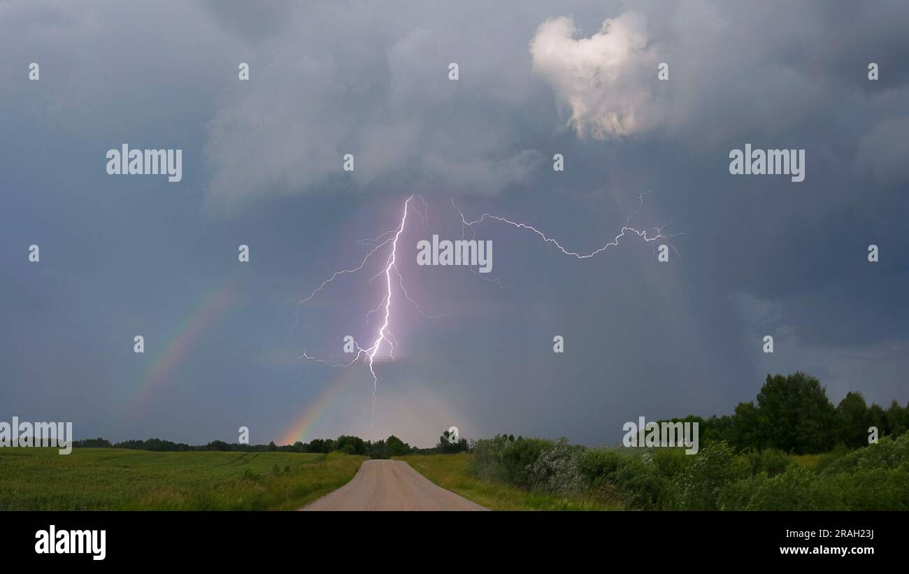 Lightning strike over the rainbow. Stormy landscape Stock Photo - Alamy