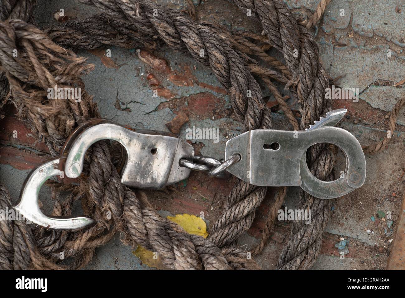 handcuffs lie on an old canal on a wooden board in the street, an ...