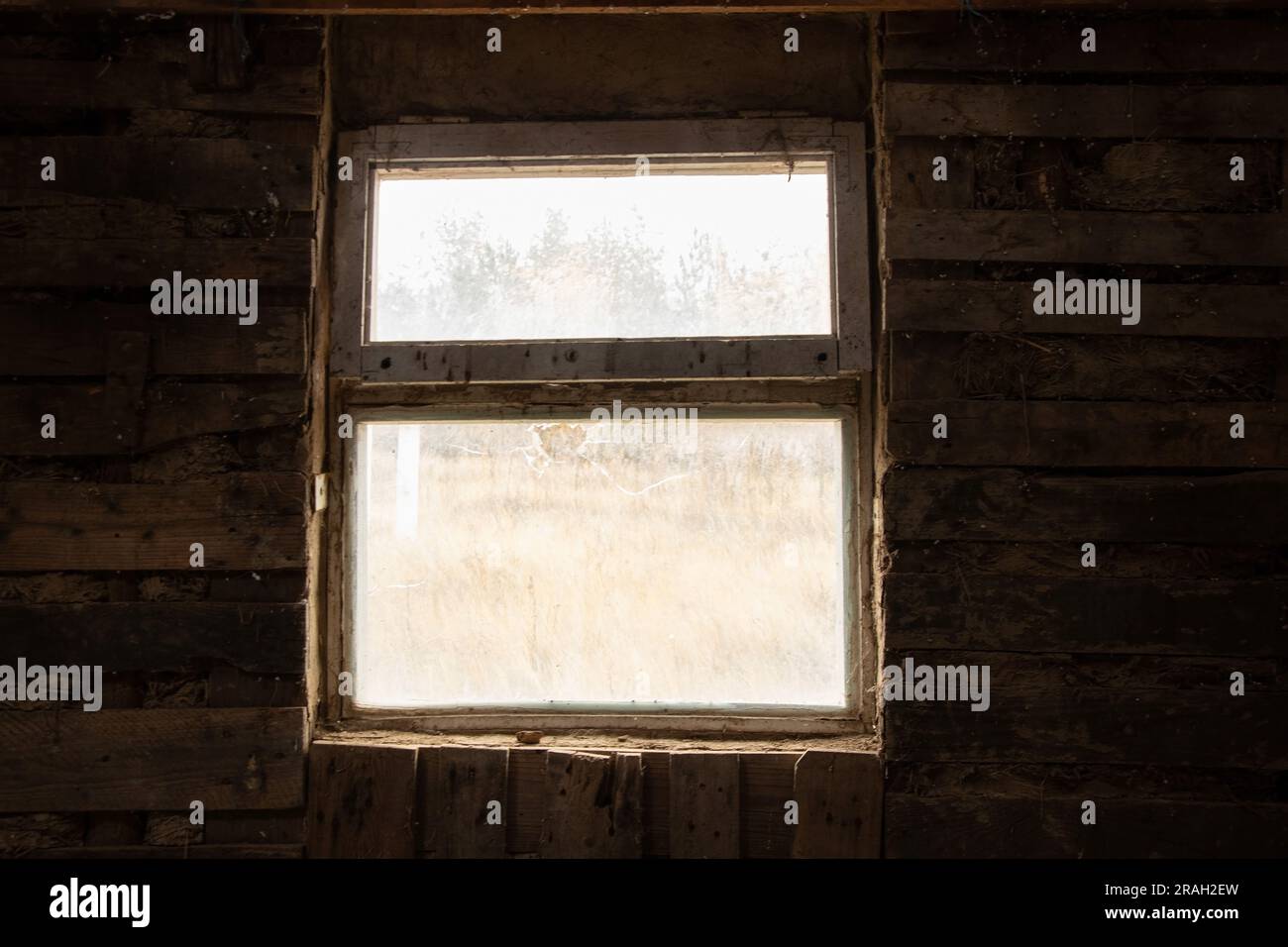 window on an old wall of a house made of clay in the countryside in ...