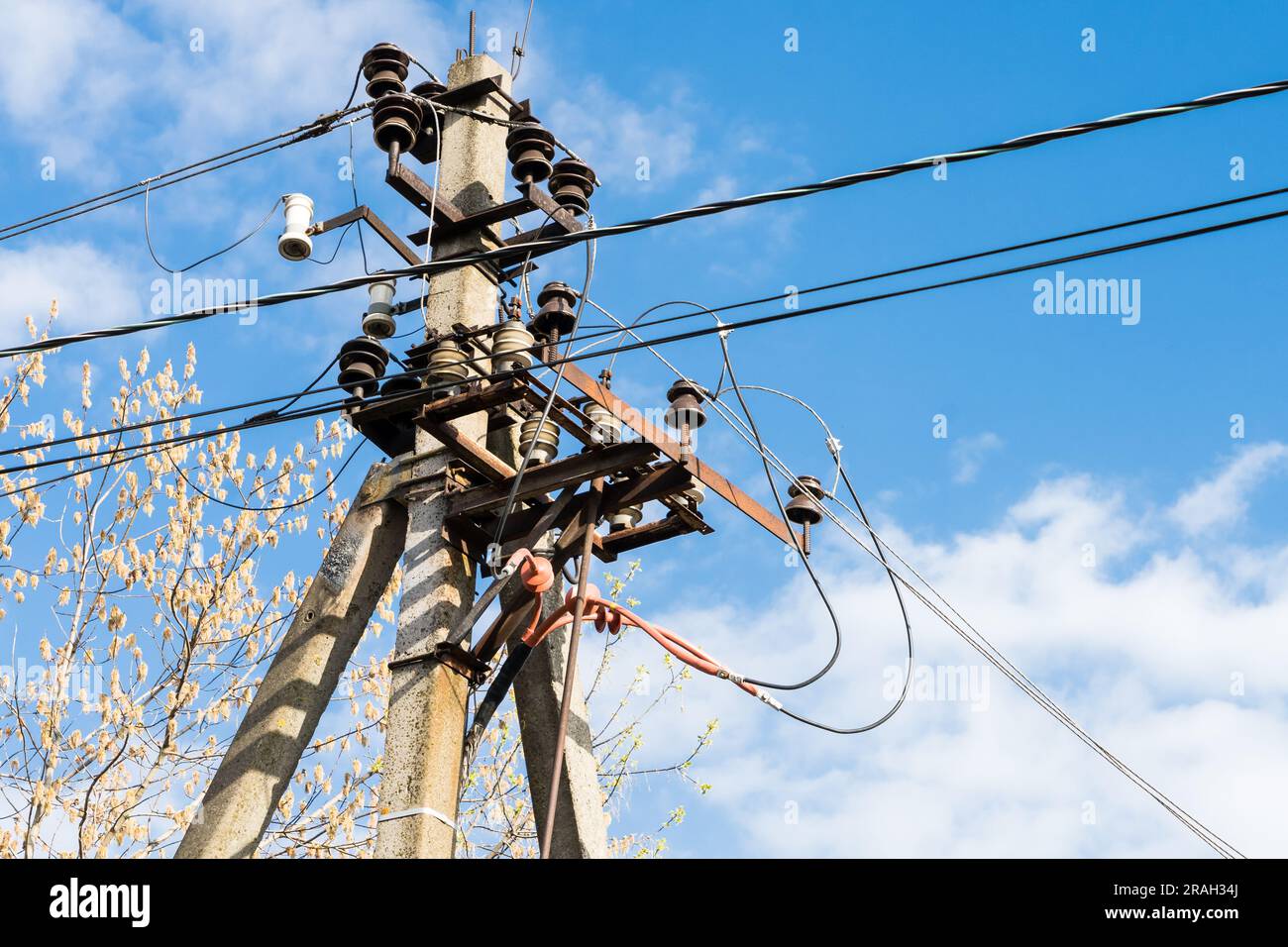 Concret power line pole hub with two support poles and metal fasteners ...
