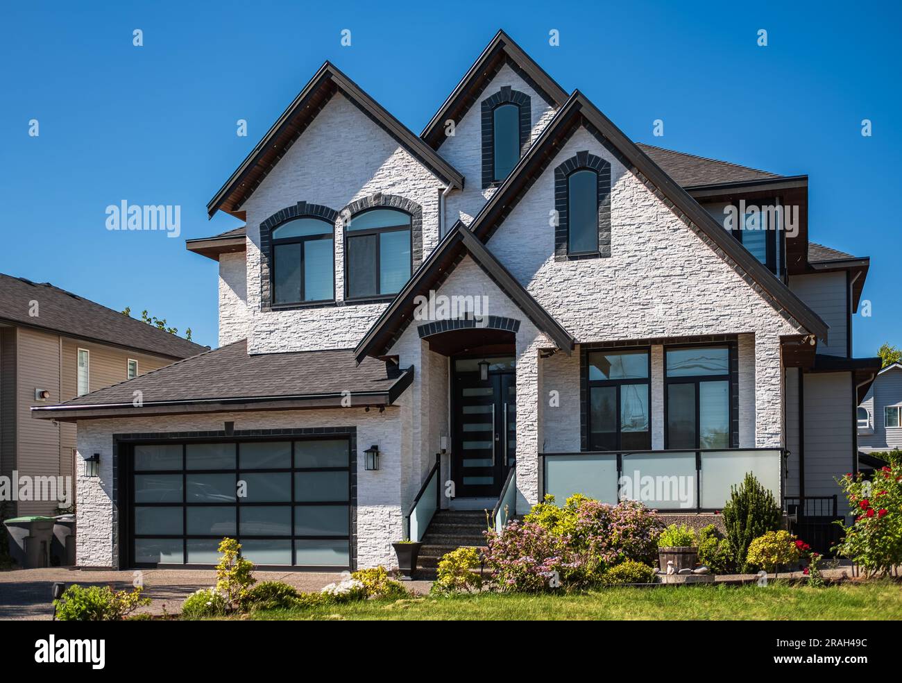 Real Estate Exterior Front House on a sunny day. Big custom made luxury ...