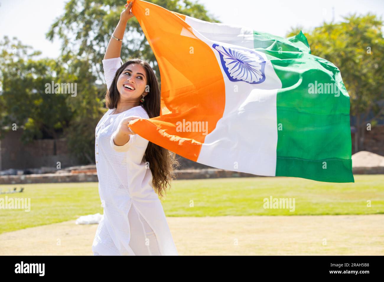 Happy Young Woman Wearing Traditional White Dress Running With Big