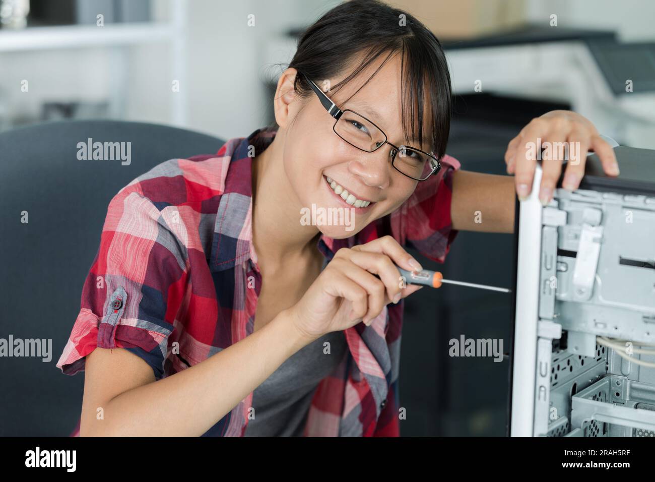 happy female pc technician fixing a desktop computer Stock Photo - Alamy