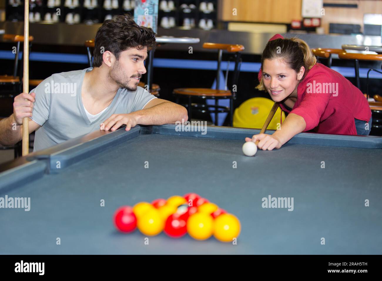 portrait of couple playing pool together Stock Photo - Alamy