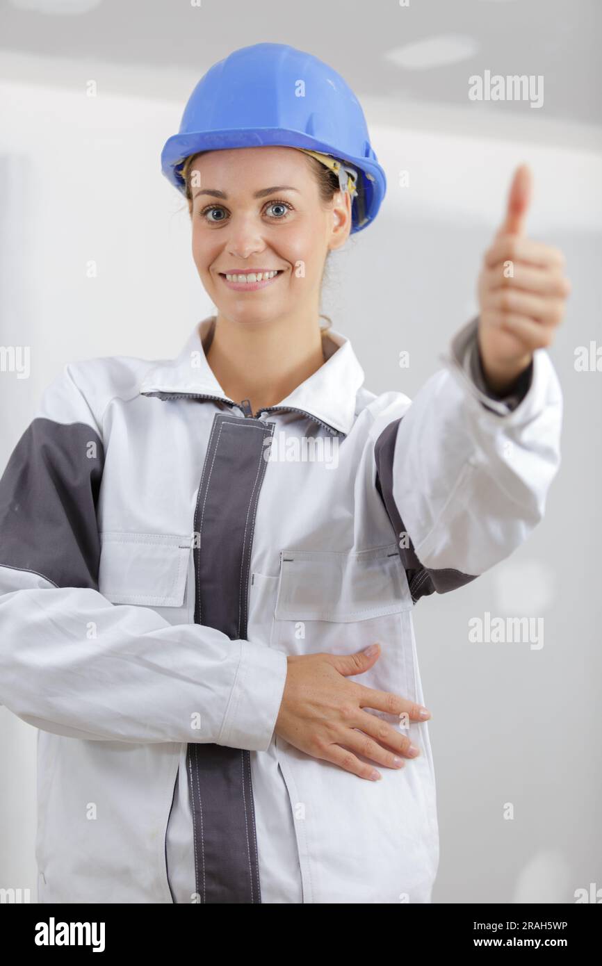 portrait of female tradesperson making thumbs up gesture Stock Photo - Alamy
