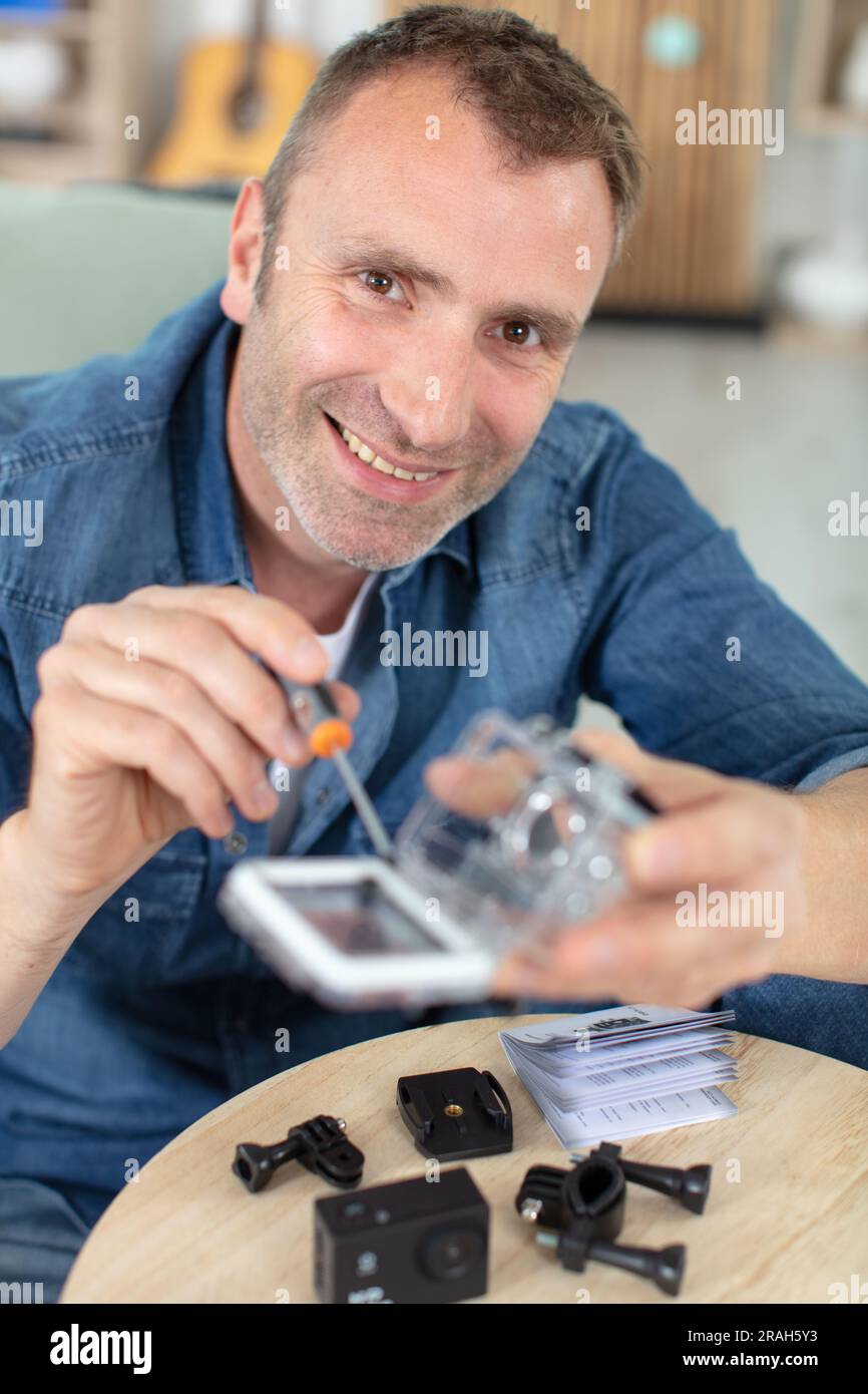 man assembling the components of an actioncam Stock Photo - Alamy