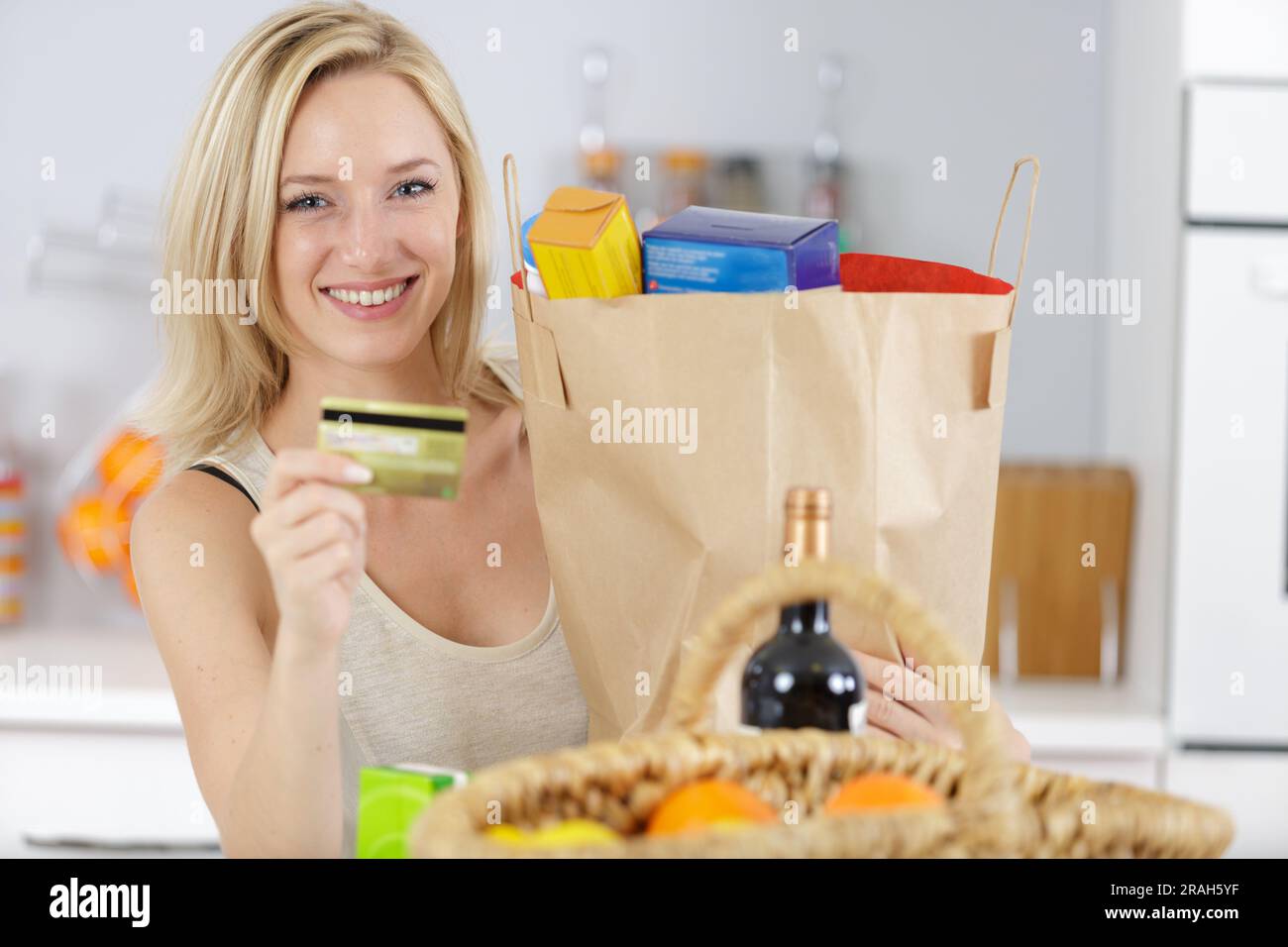 woman is pleasantly surprised after grocery shopping Stock Photo - Alamy