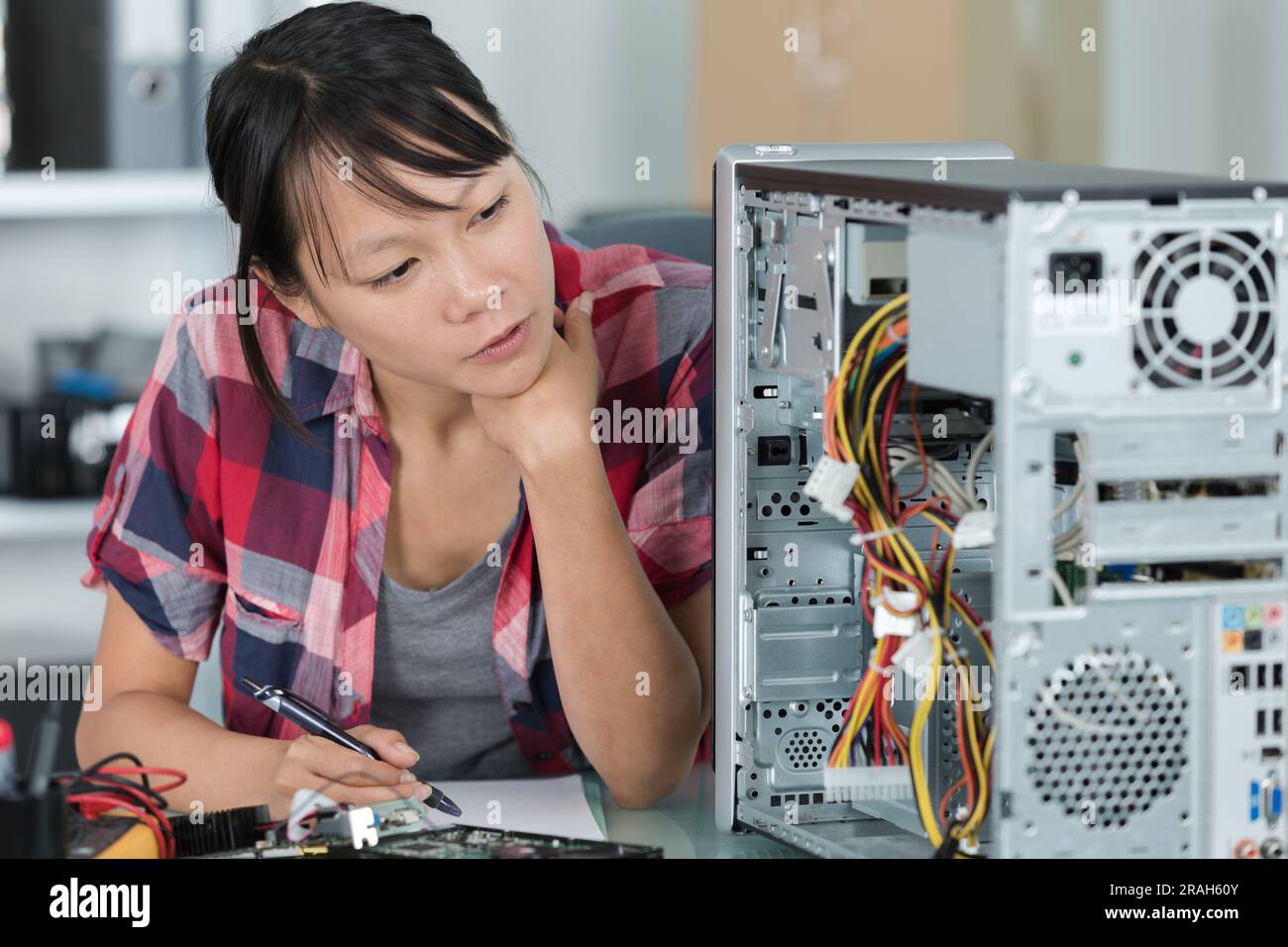 young female student fixing a pc components in classroom Stock Photo ...