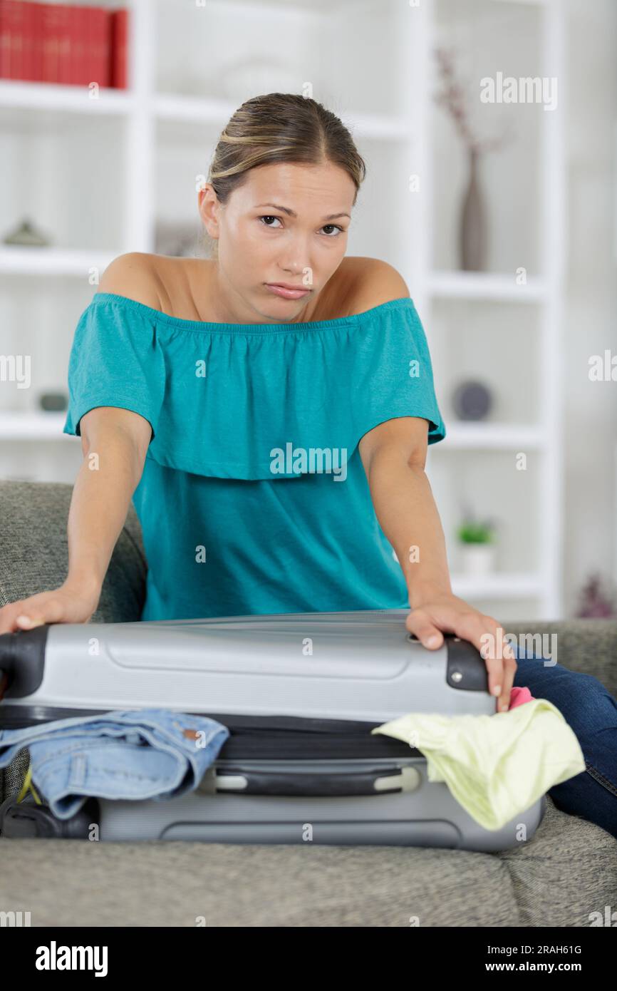 Woman packing a suitcase sad hi-res stock photography and images - Alamy