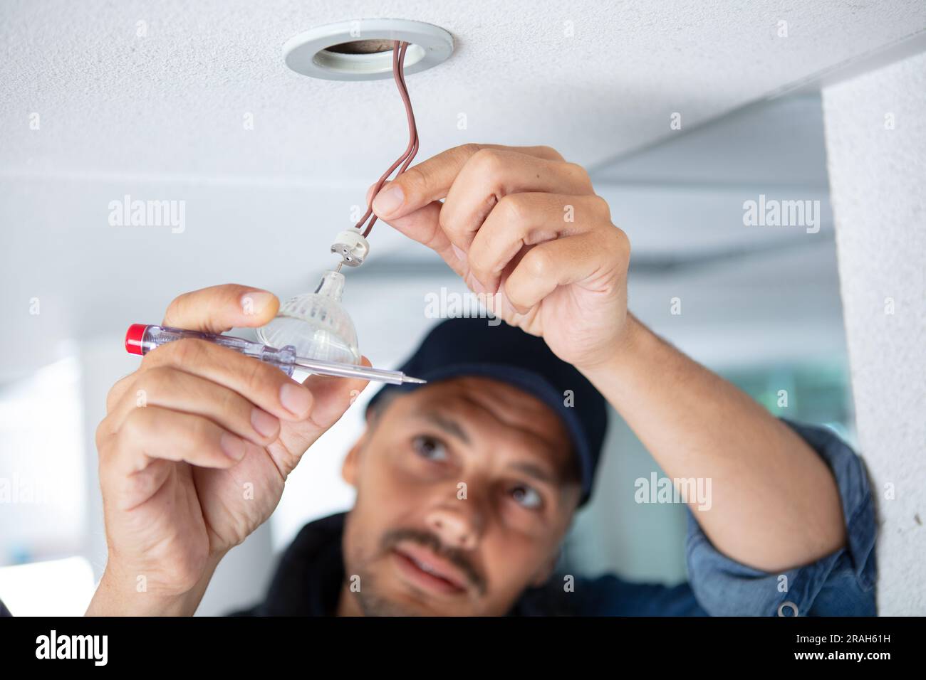 Man repairing light fixture hi-res stock photography and images - Alamy