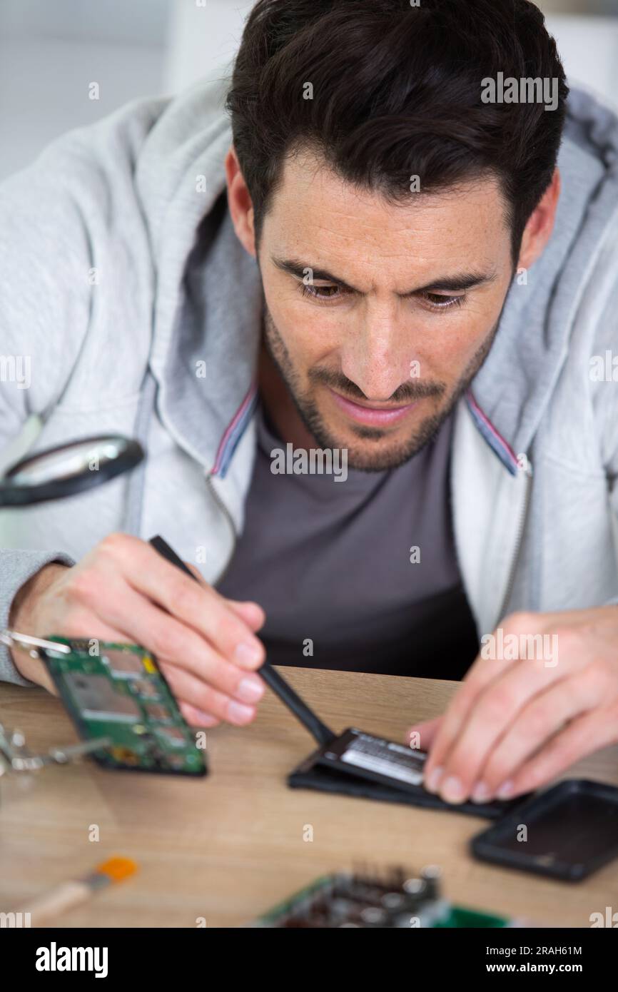 Male tech repairs electronic equipment hi-res stock photography and ...