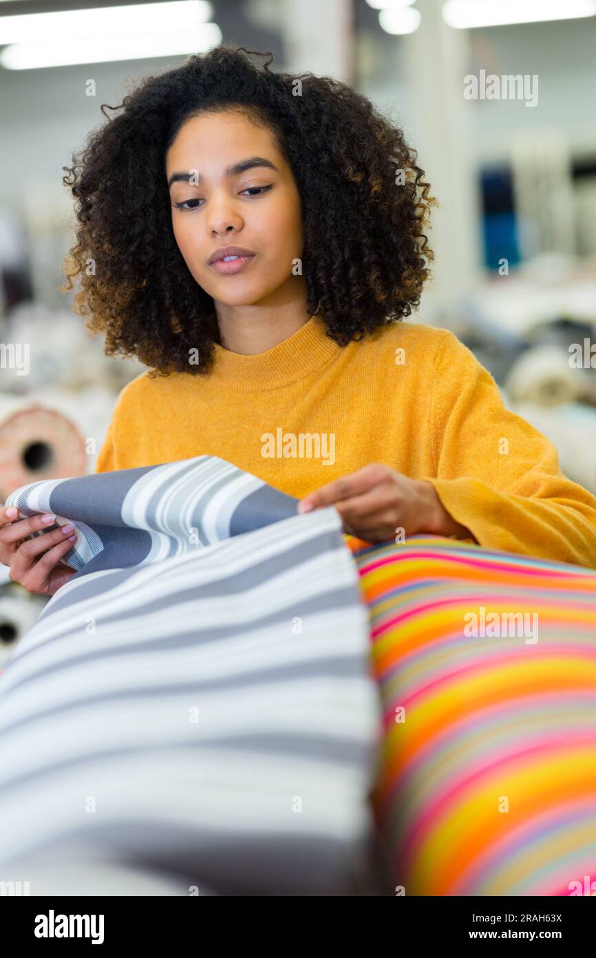 woman picking a perfect stripped designed fabric Stock Photo - Alamy