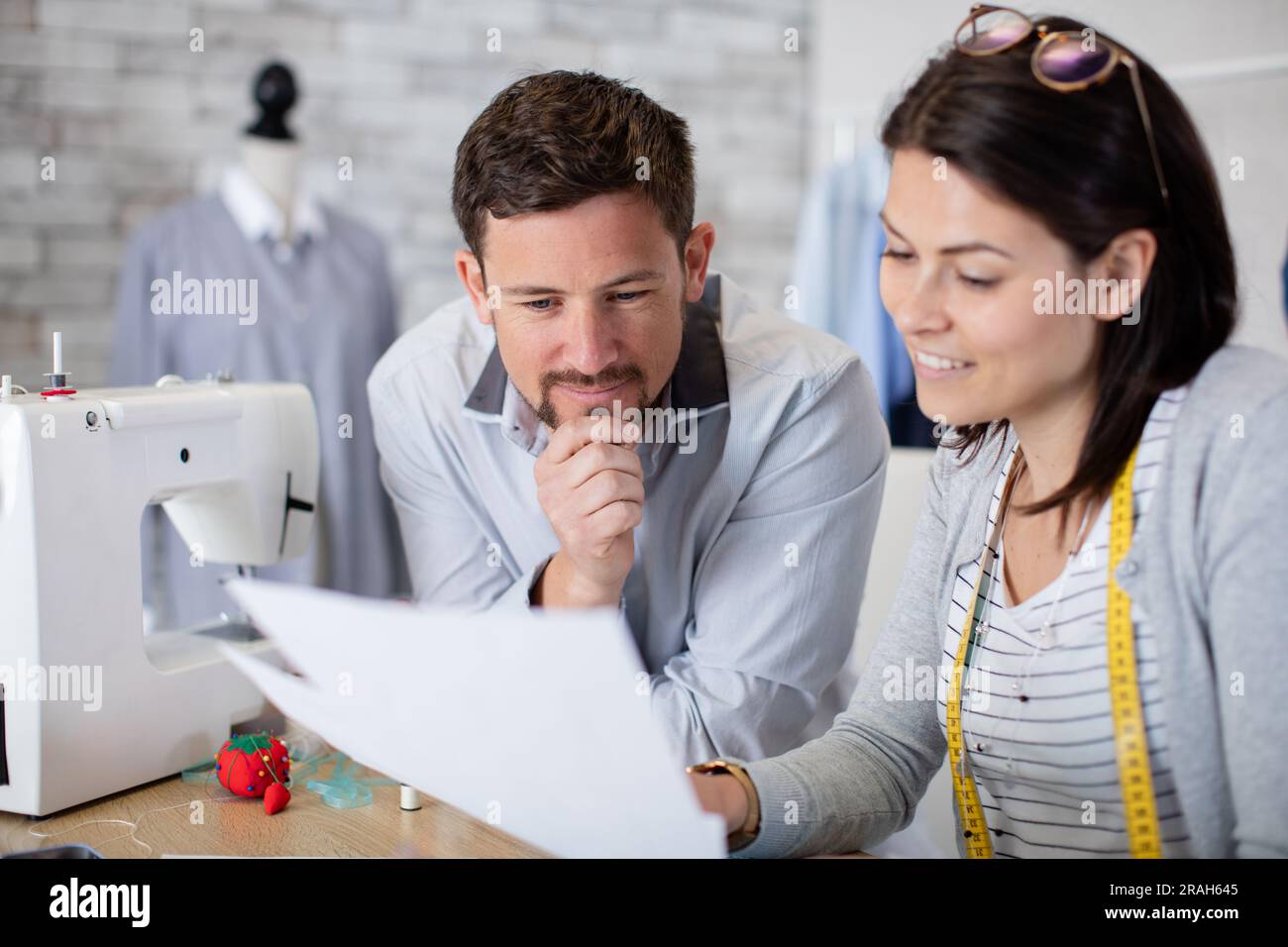 young dressmakers working on rough outline designs at workshop Stock ...