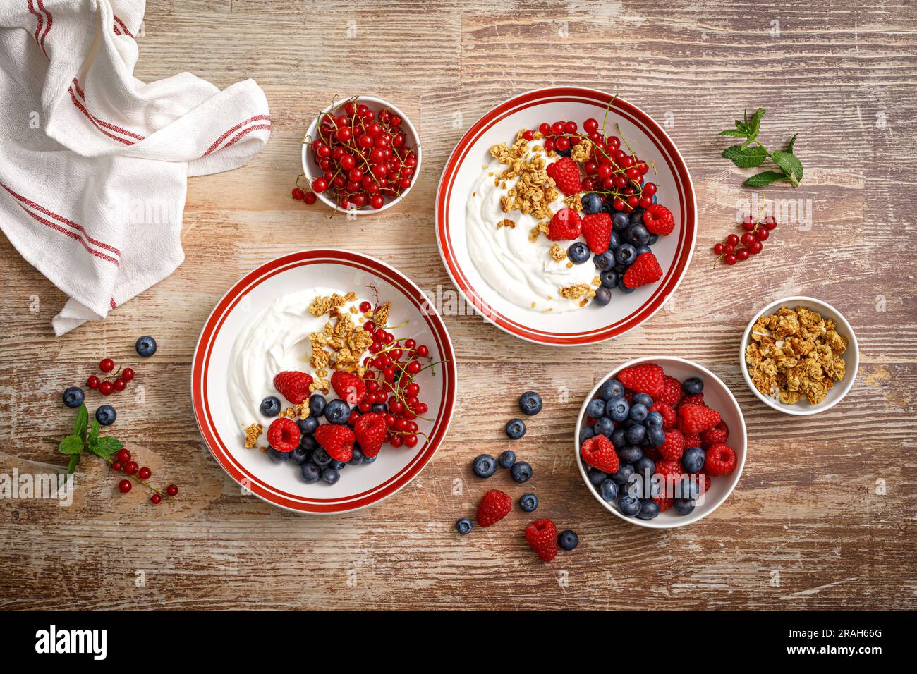 Yogurt with berries on wooden background. White plain greek yogurt with ...