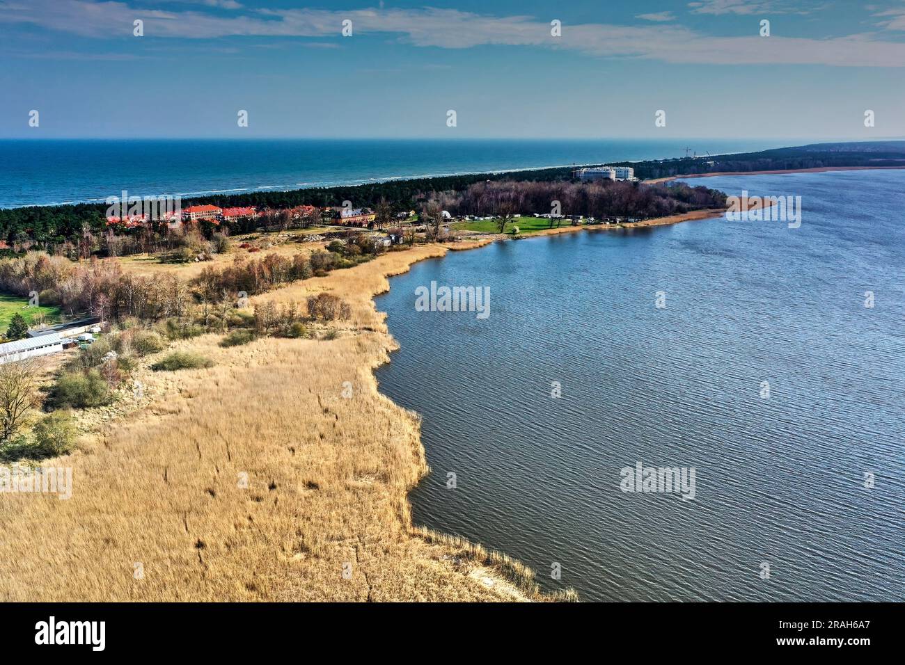 Aerial view of a narrow strip of land between a lake and the Baltic Sea ...