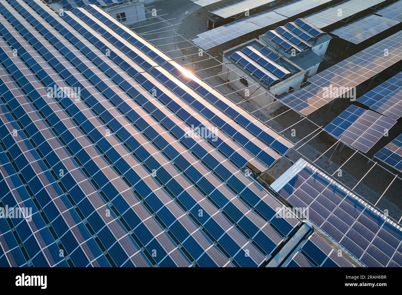Aerial view of solar power plant with blue photovoltaic panels mounted ...