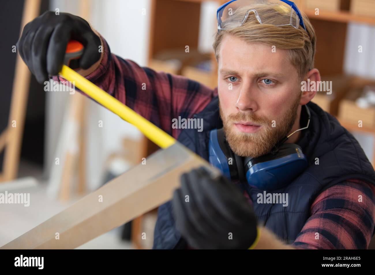 worker in workshop measuring metal Stock Photo - Alamy