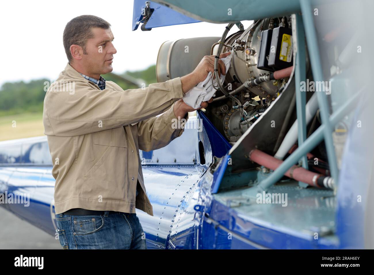 man working with an engine Stock Photo - Alamy