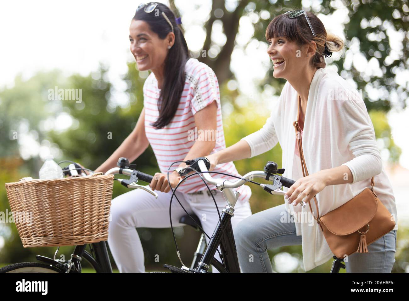 two women having fun cycling Stock Photo - Alamy