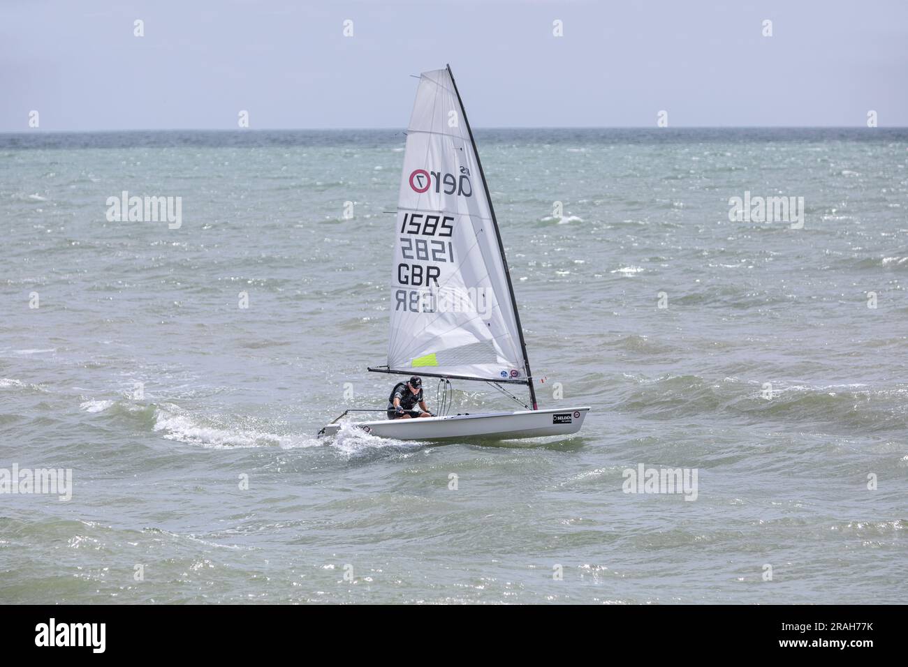 A man sailing in a small boat on a choppy sea Stock Photo - Alamy