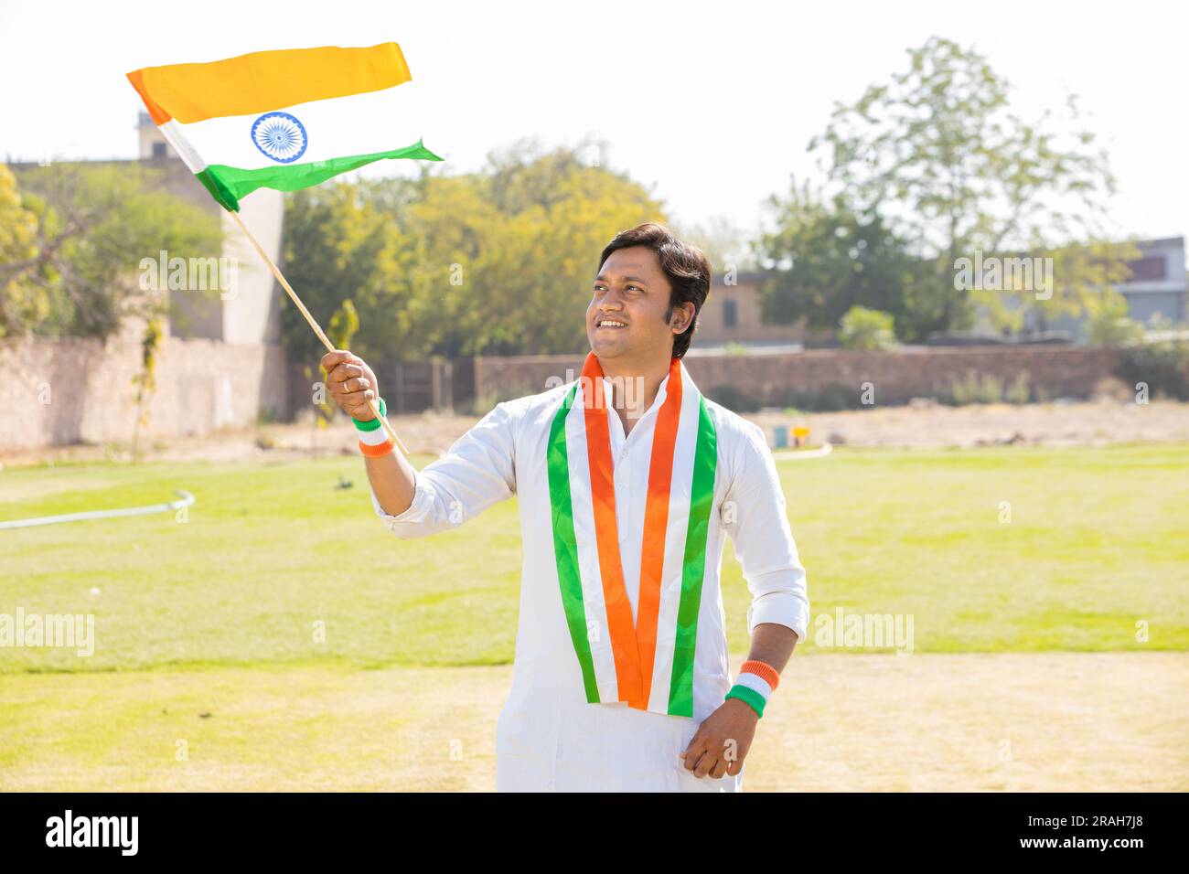 happy young man wearing traditional white dress holding indian and ...