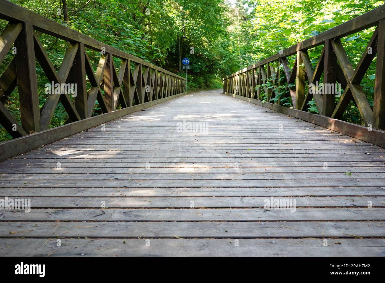 Wooden bridge in the forest. Bridge for pedestrians and bikers in the ...