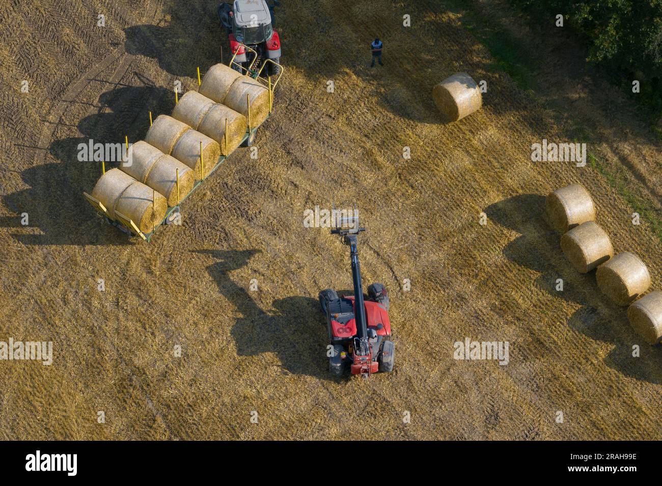 Aerial view of tractor collecting straw bales,Agricultural machine ...