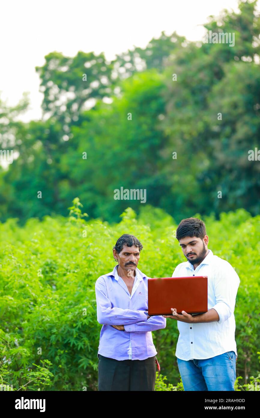 Indian farmer holding laptop, smart farming Stock Photo - Alamy