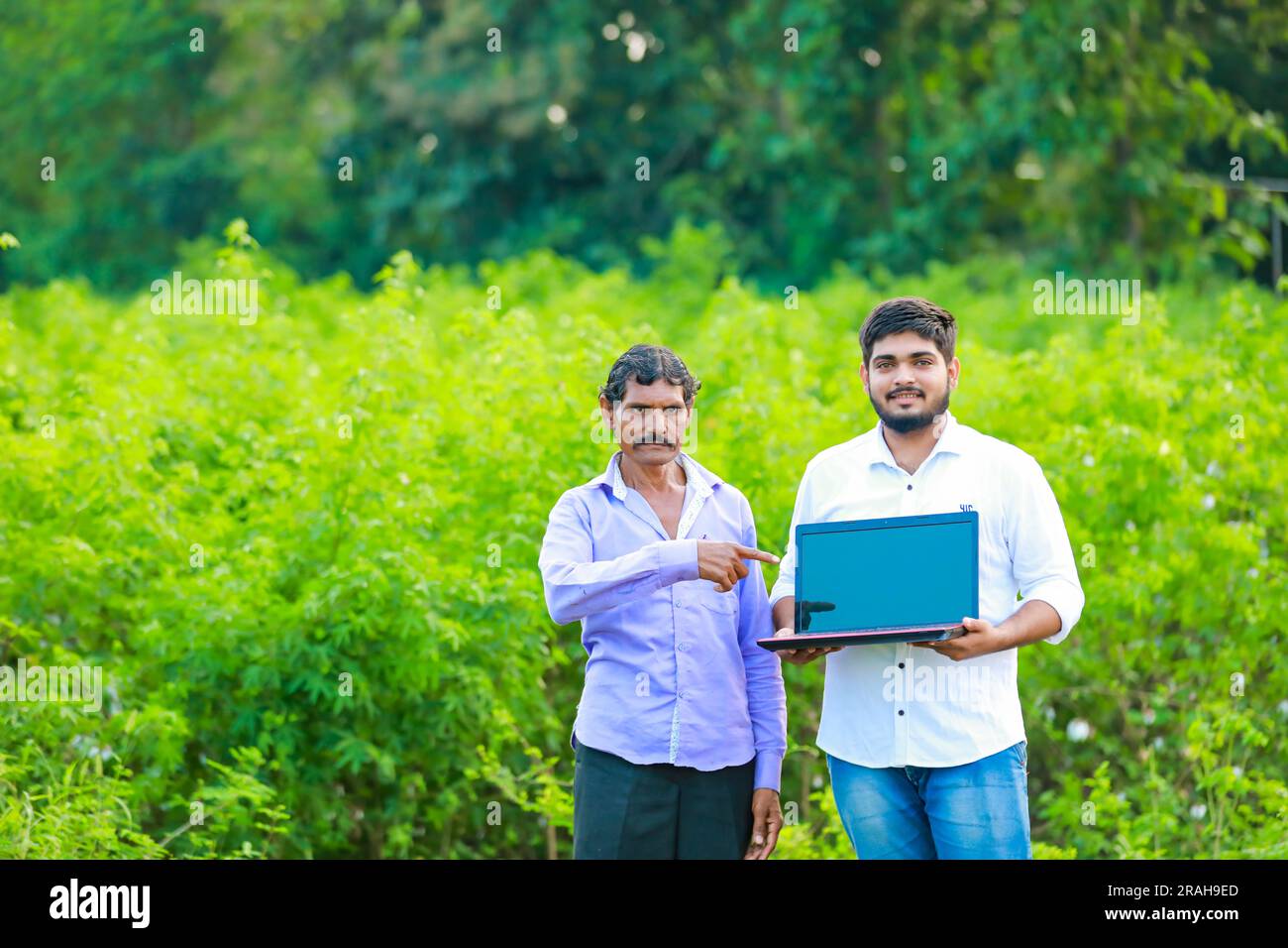 Indian farmer holding laptop, smart farming Stock Photo - Alamy