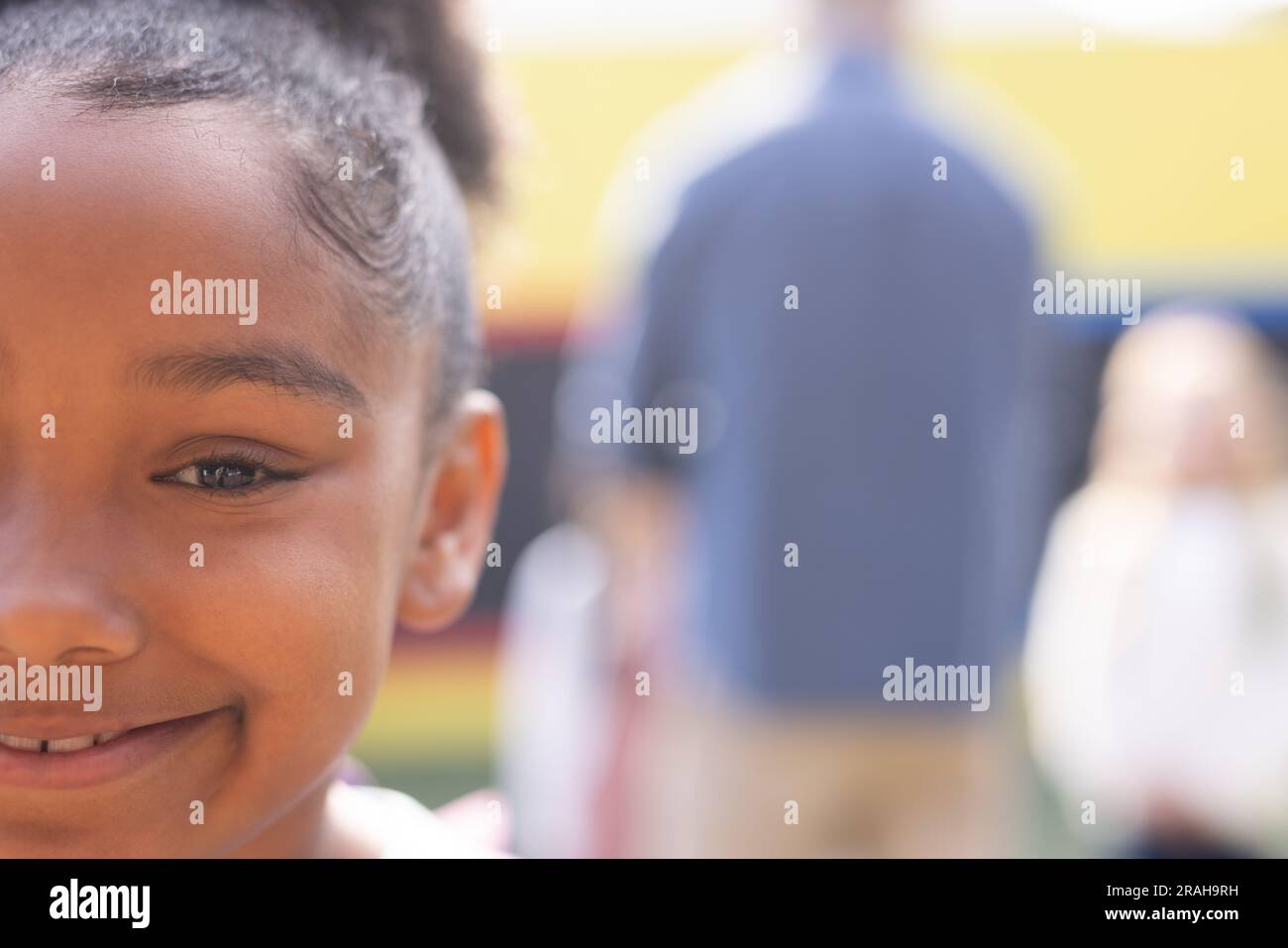 Half face portrait of smiling african american elementary schoolgirl in ...