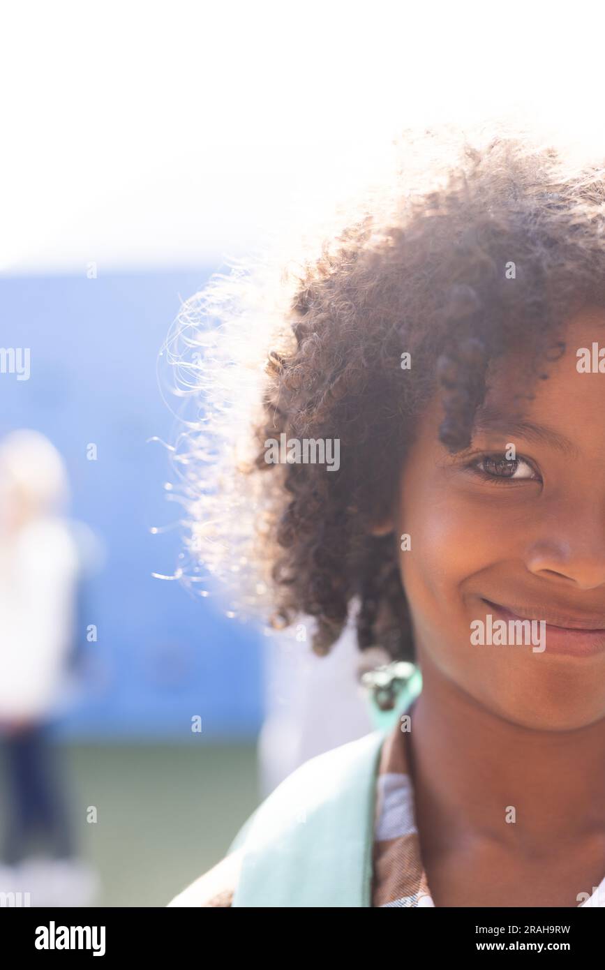 Vertical half face portrait of smiling african american elementary ...