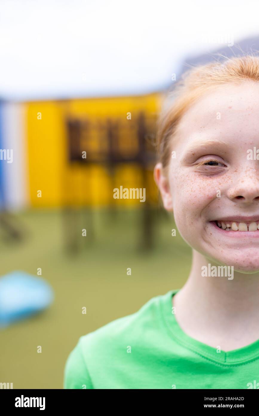 Vertical half face portrait of smiling caucasian schoolgirl in ...