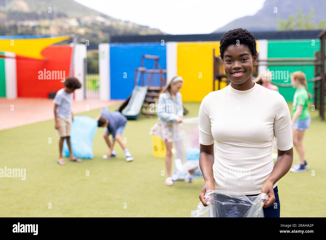 Portrait of smiling african american female teacher collecting ...