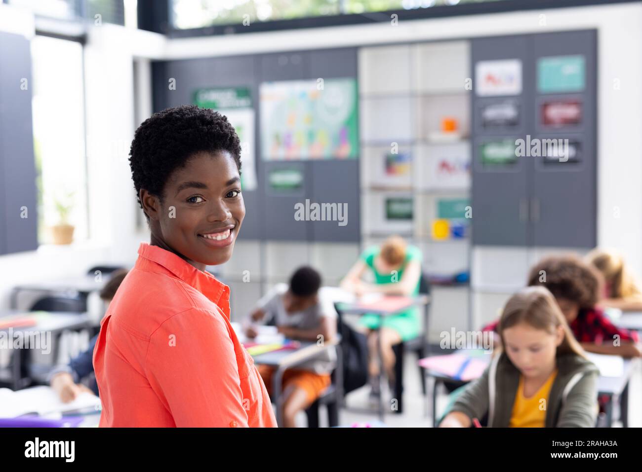 Portrait of happy african american female teacher in classroom with ...