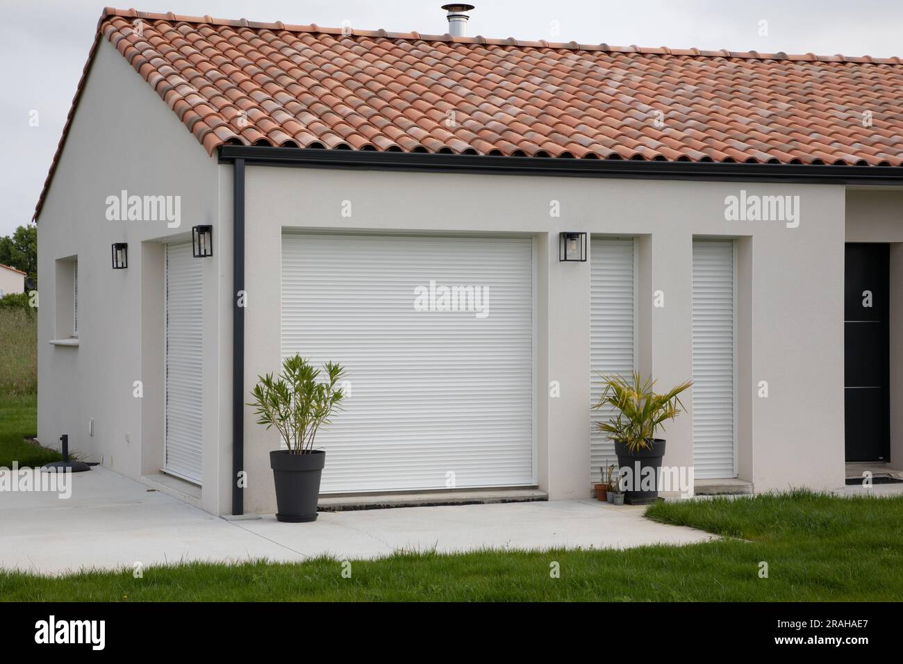 facade of modern house with terrace and closed pvc rolling shutters of ...
