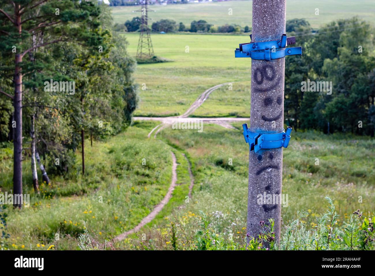 View from a high point to a splashing rural road. Electric pole with ...