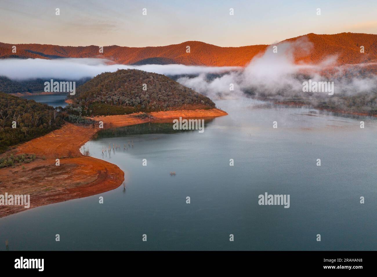 Aerial view of morning fog rising of the waters surface of Lake Eildon ...