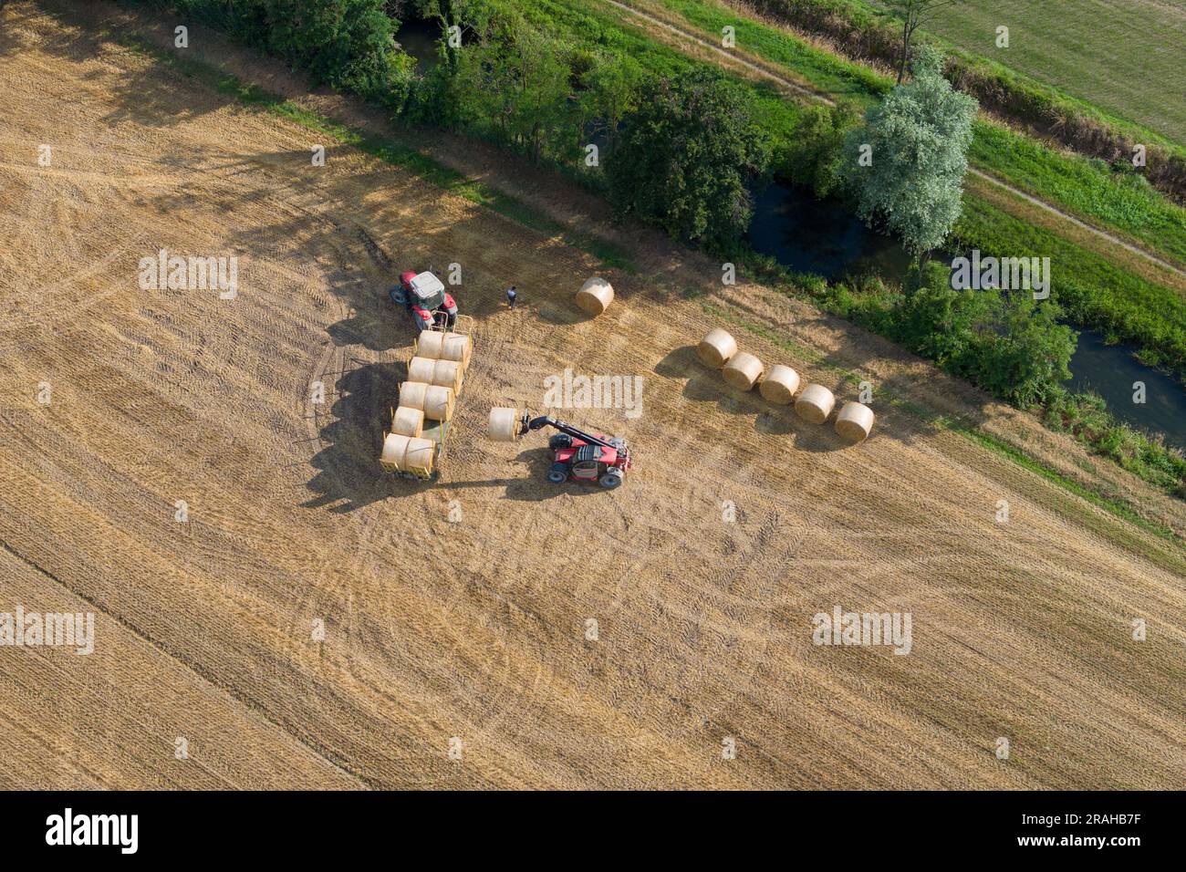 Aerial view of tractor collecting straw bales,Agricultural machine ...