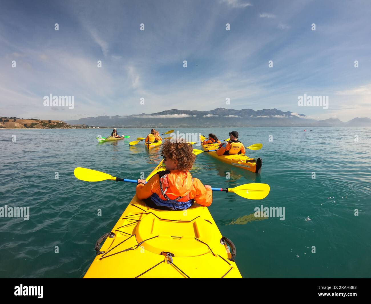 A family enjoys a dramatic open sea kayak trip along the coastline of ...
