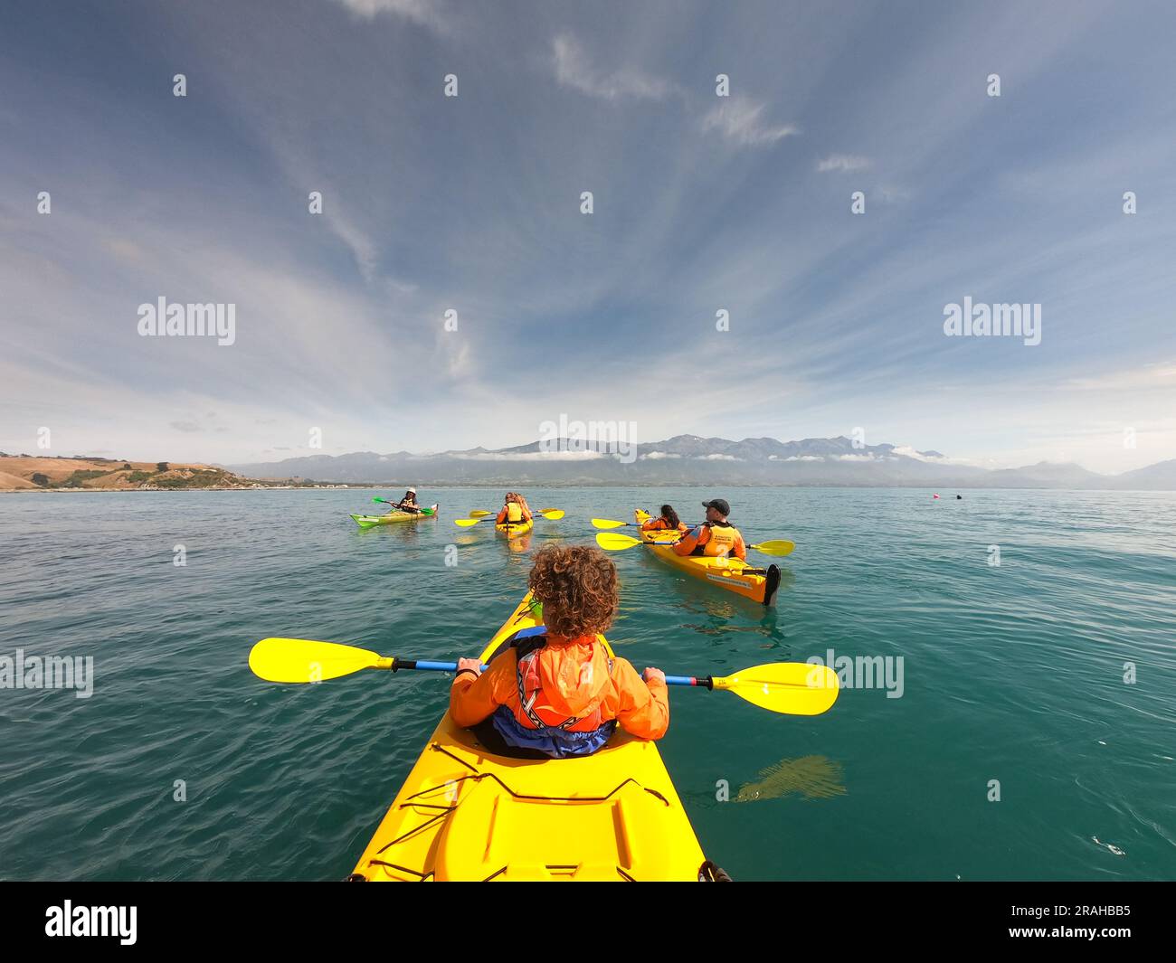 A family enjoys a dramatic open sea kayak trip along the coastline of ...