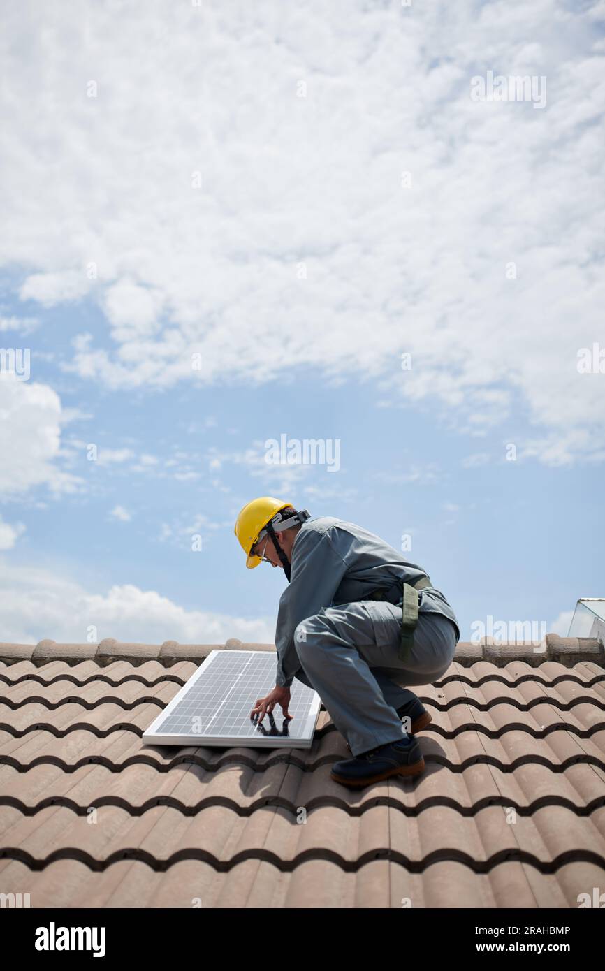 Solar contractor installing panels on roof, renewable energy concept ...