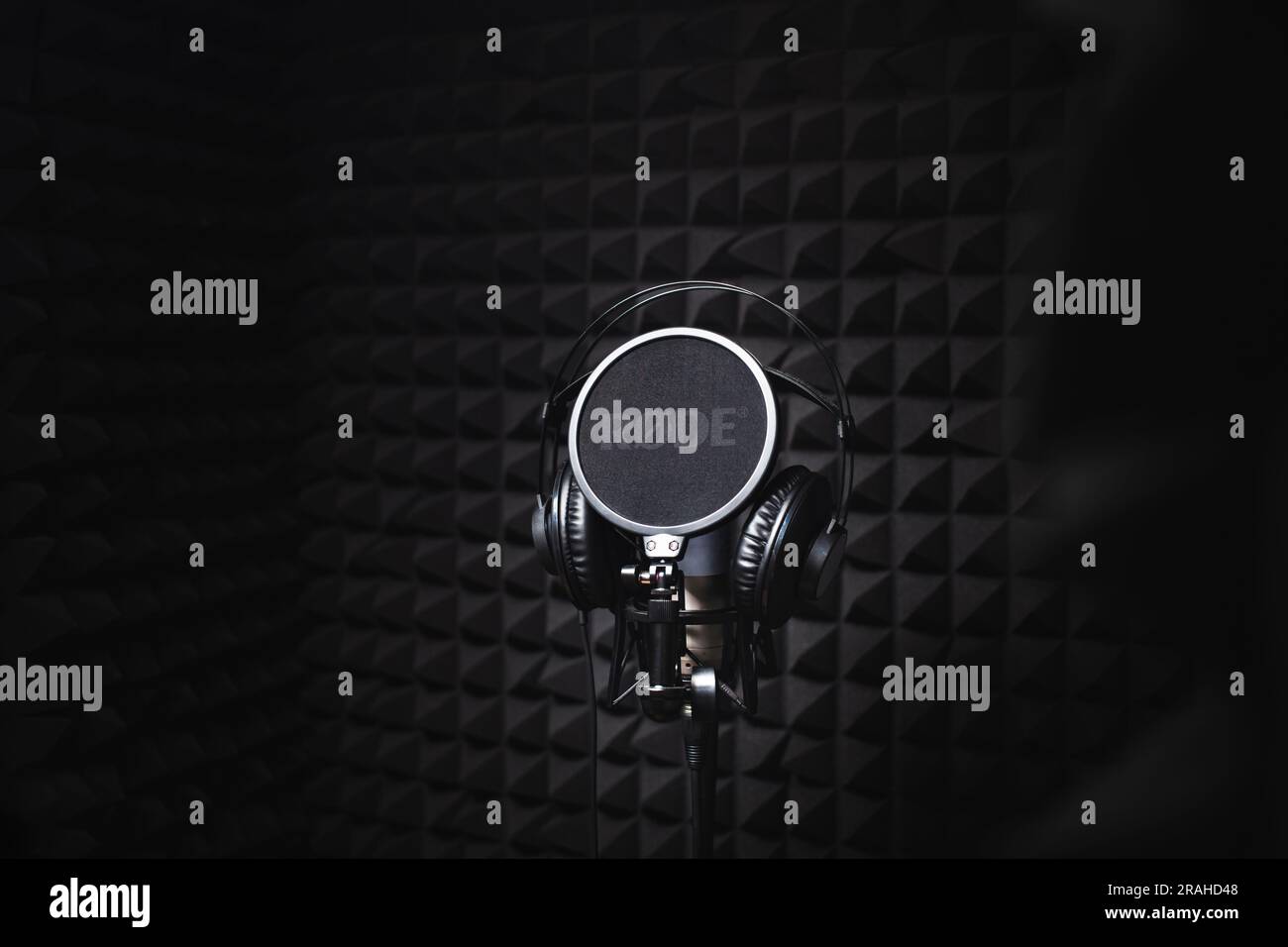 Moldova, Tiraspol, 05.05.2022 Microphone, headphones for singing, recording studio, black noise ...