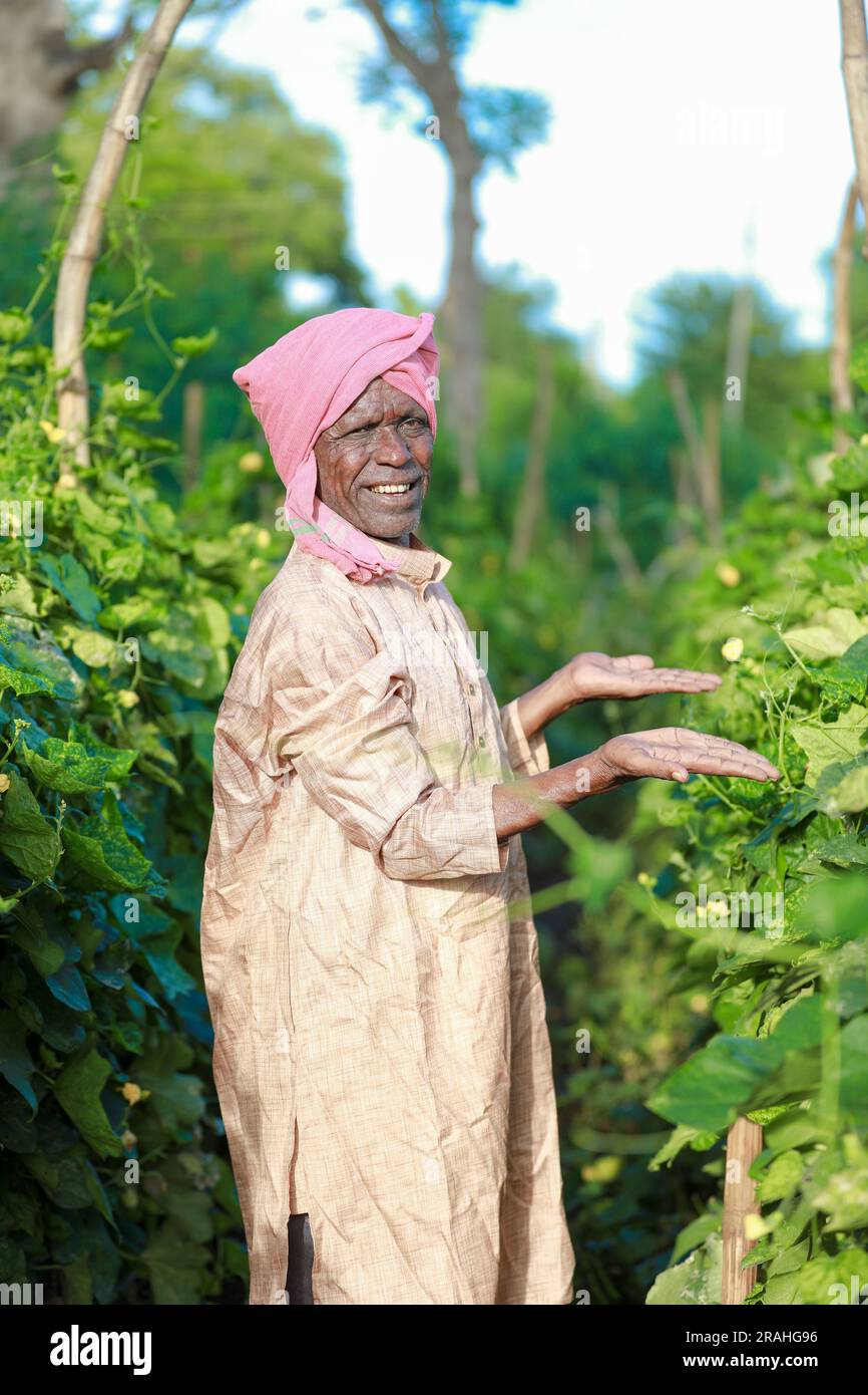 Indian farming Happy indian farmer standing in farm, sowing Empty Hands ...
