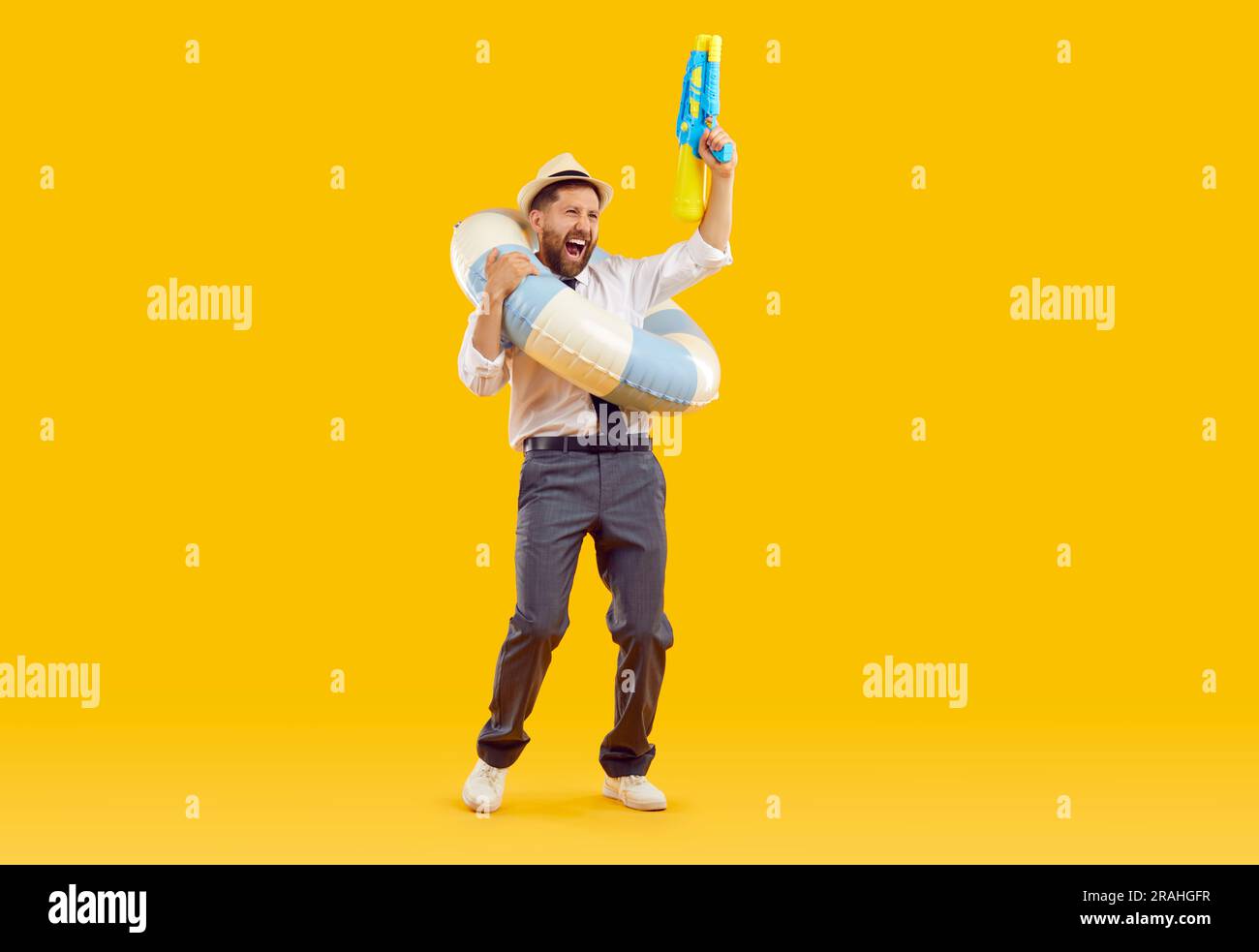 Funny happy crazy office worker with beach ring and water gun having ...