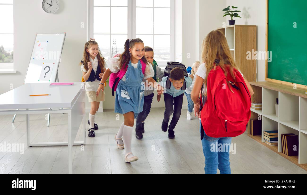 Funny elementary school students having fun and fooling around together ...