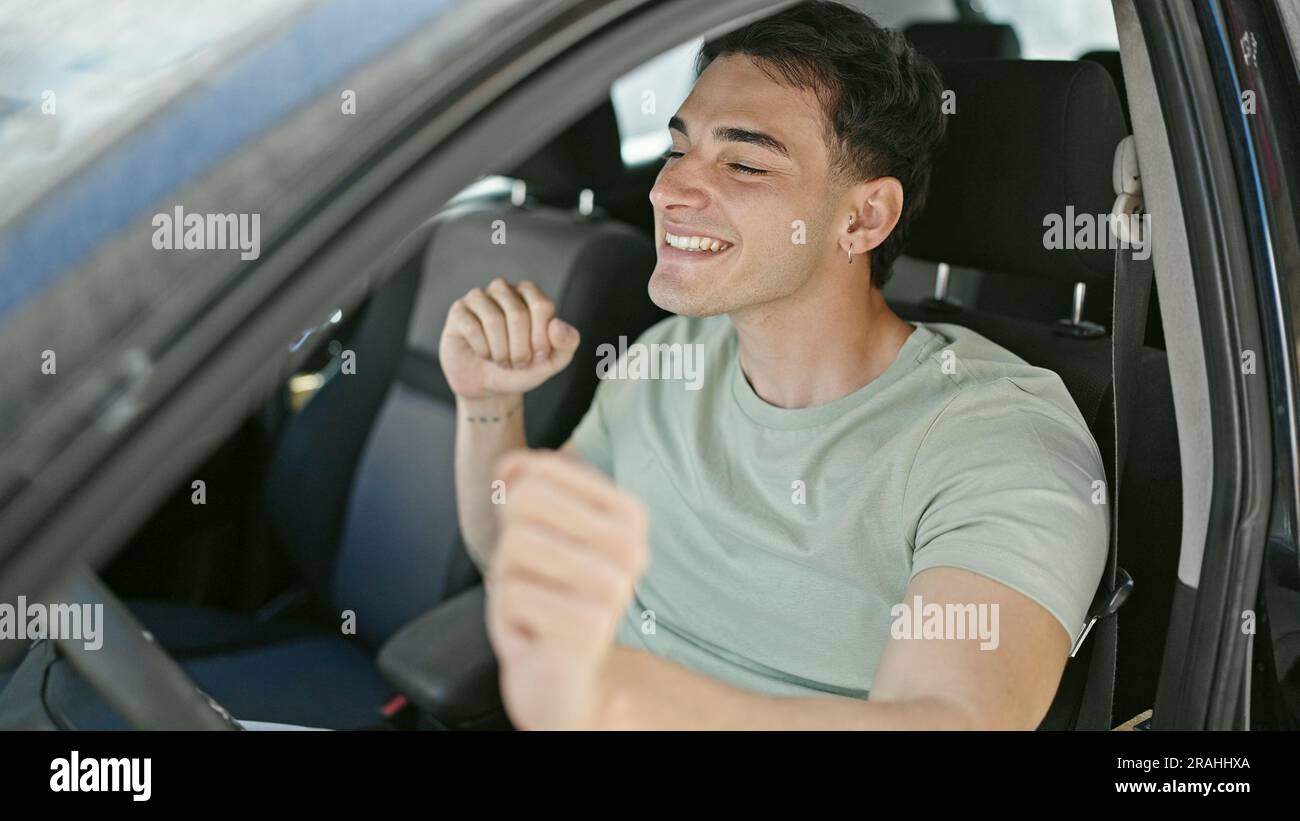 Man driving car dancing listening hi-res stock photography and images ...