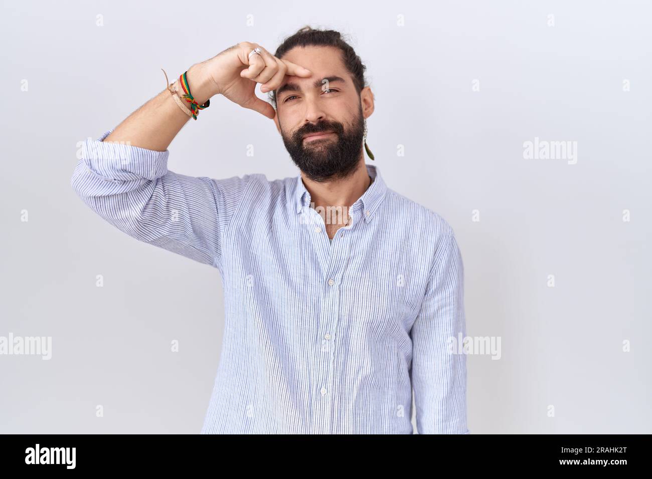 Hispanic man with beard wearing casual shirt pointing unhappy to pimple ...